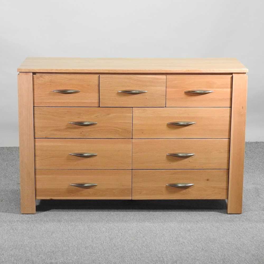 Lot 452 - A modern light oak chest of drawers